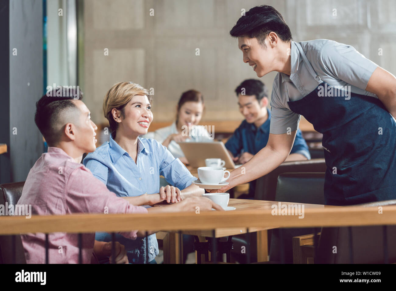 Couple being served coffee hi-res stock photography and images - Alamy