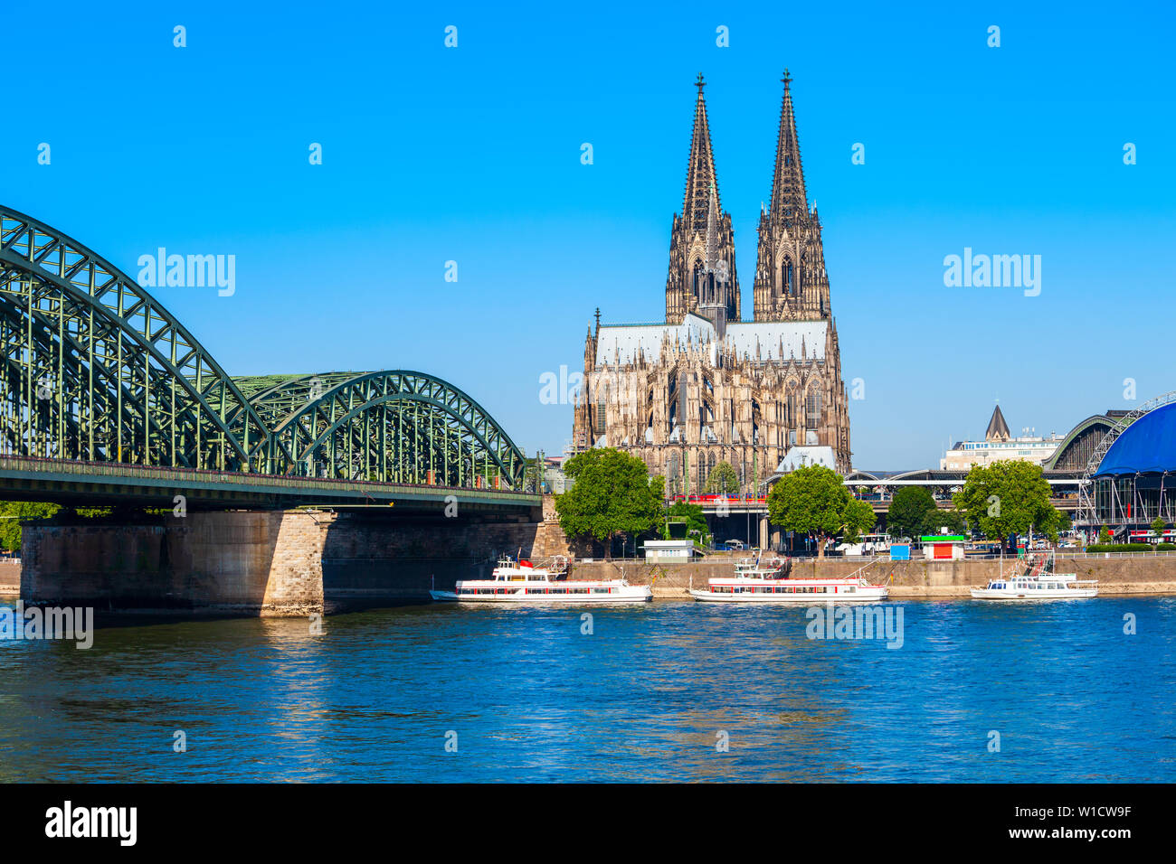 Cologne Cathedral and Hohenzollern Bridge through Rhine river in ...