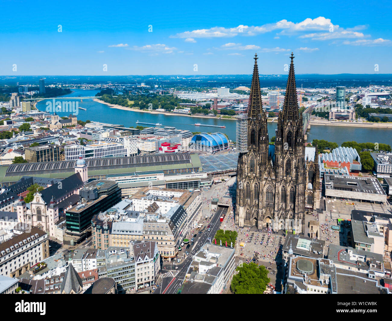 Cologne Cathedral and Hohenzollern Bridge through Rhine river in ...