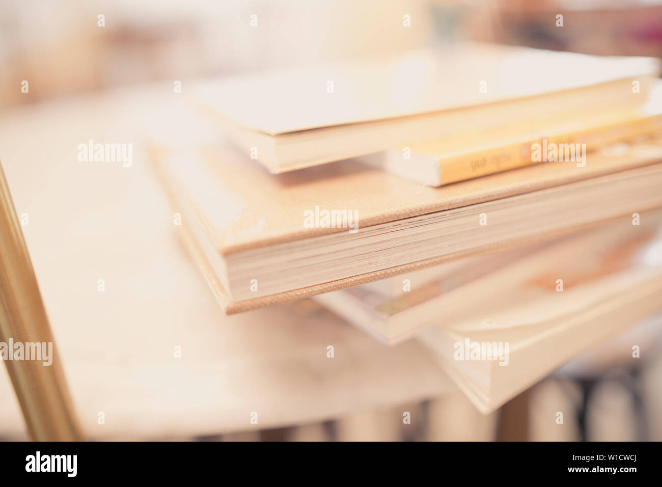close up books stacking on table in room and warm light Stock Photo - Alamy