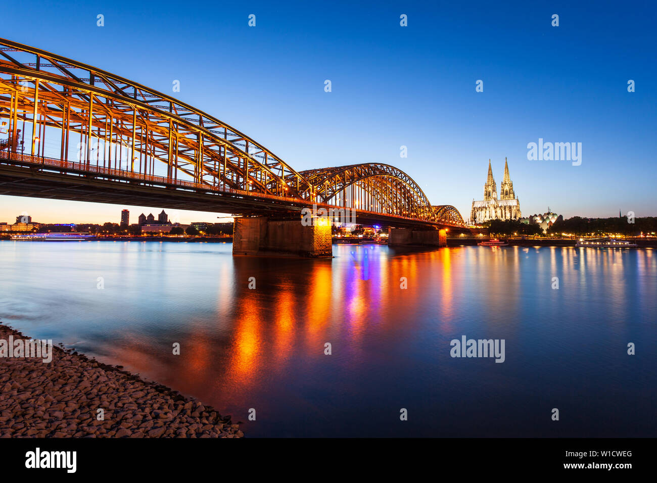 Cologne Cathedral and Hohenzollern Bridge through Rhine river in ...