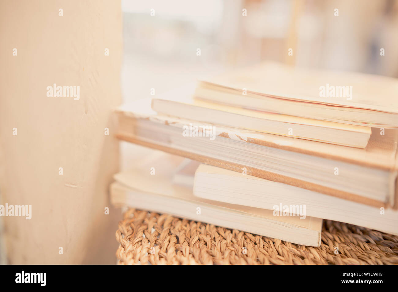 close up books stacking on table in room and warm light Stock Photo - Alamy