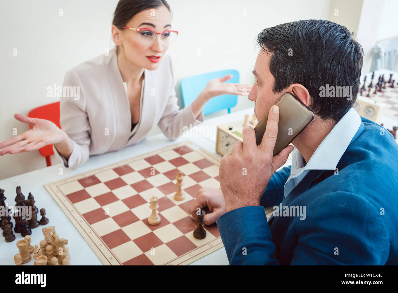Business people playing chess with man on the phone Stock Photo - Alamy