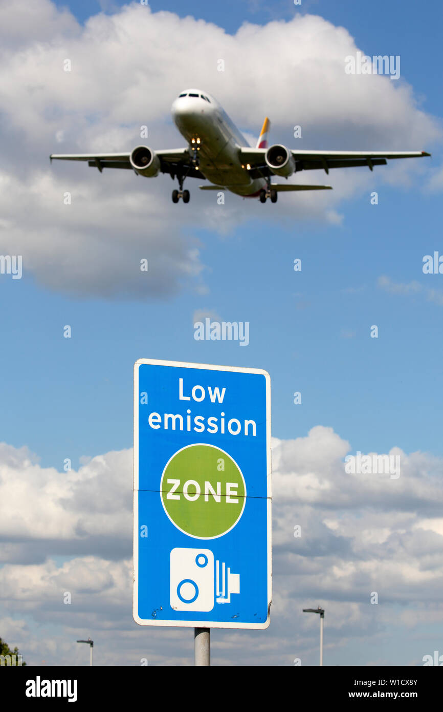 Low emissions sign beside a road under Heathrow airport approach, with ...