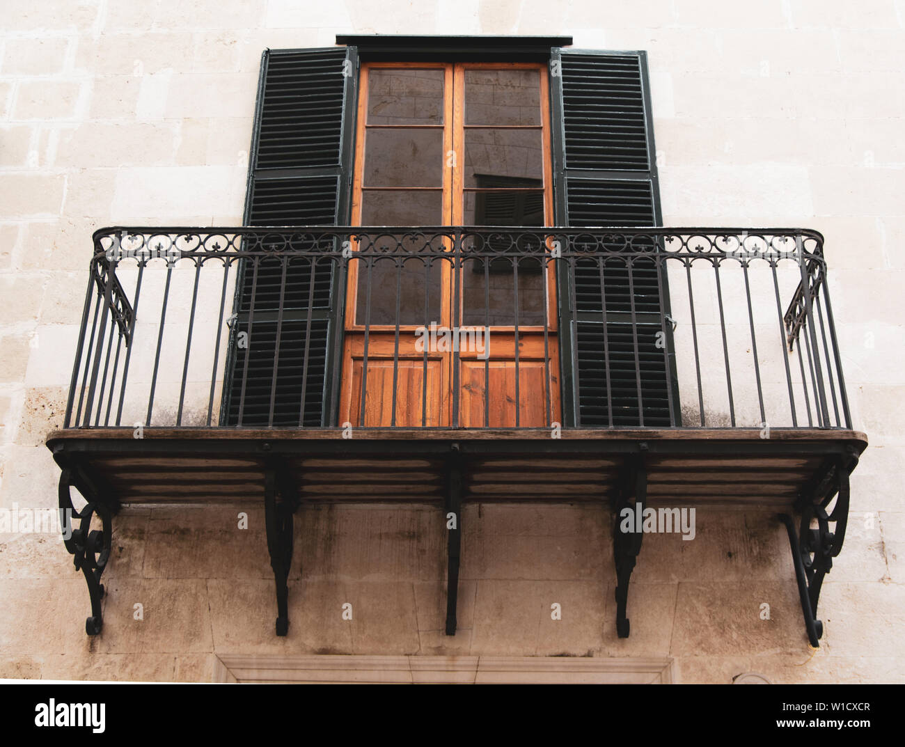 Small balcony with double door and green wooden louvre Stock Photo - Alamy