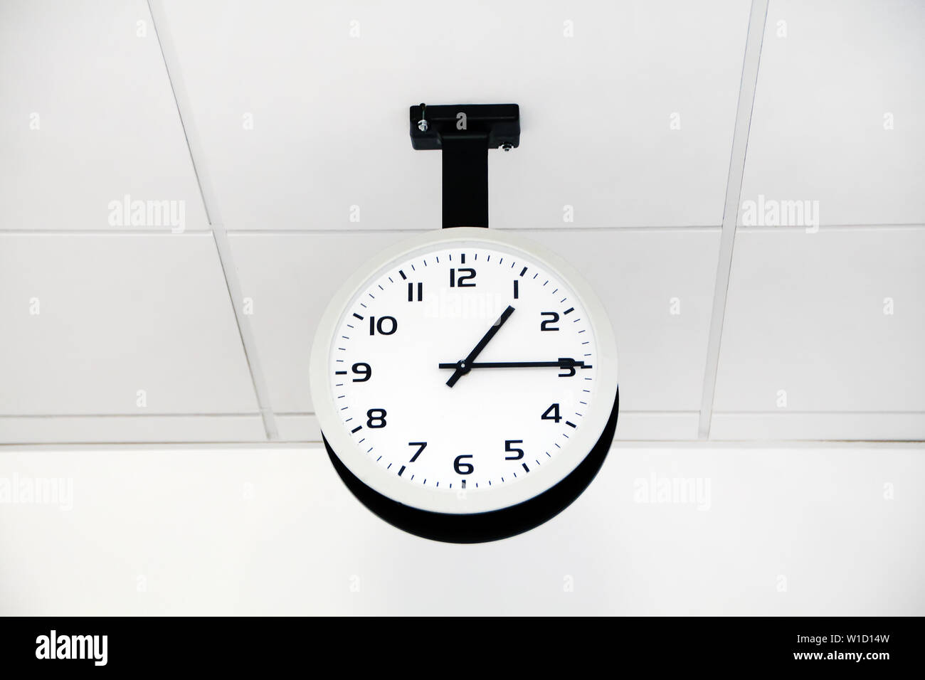 Clock hanging from ceiling hi-res stock photography and images - Alamy