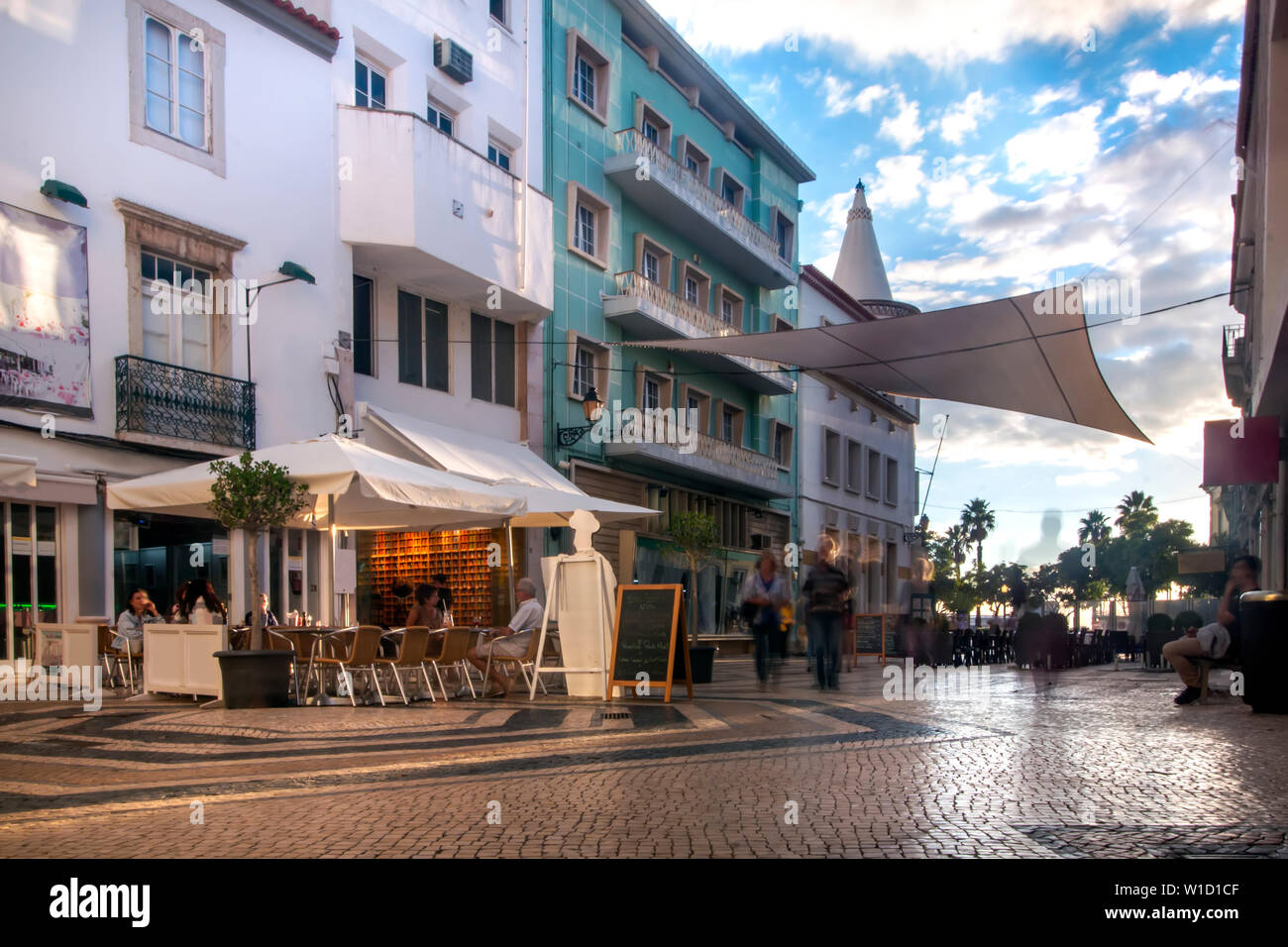 Tourist downtown area of Faro city with cobblestone streets and ...