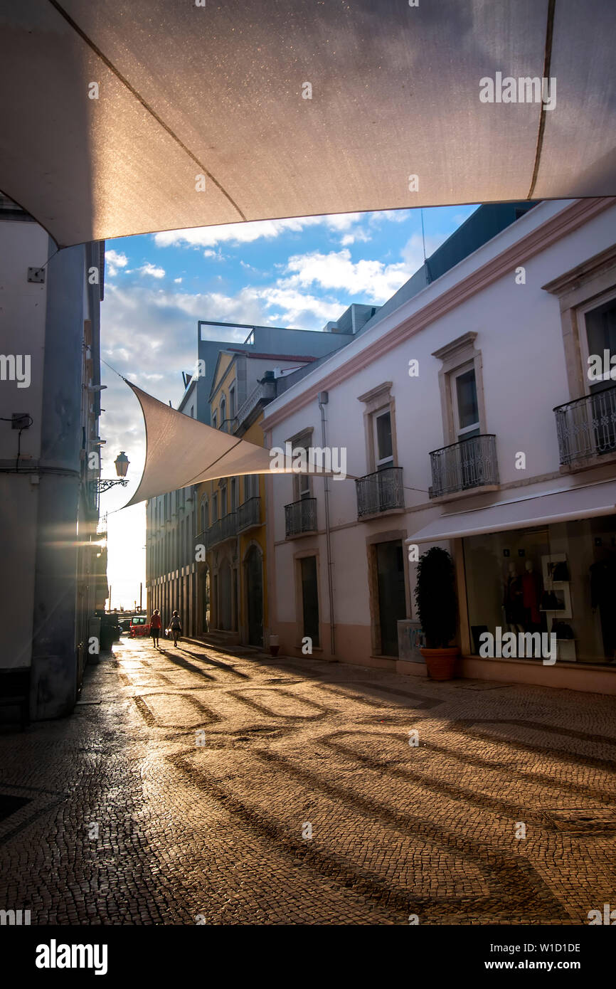 Tourist downtown area of Faro city with cobblestone streets and ...