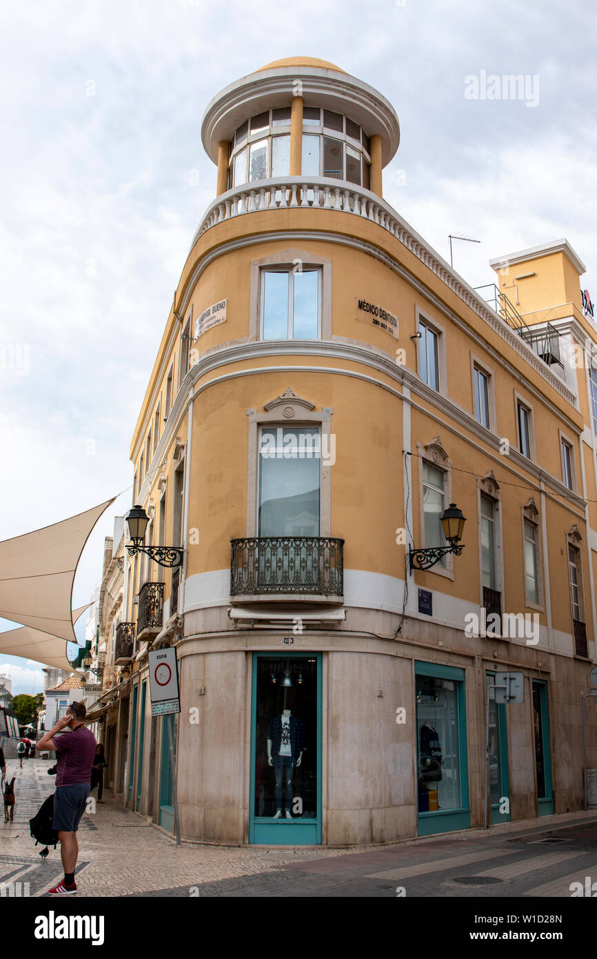Curved yellow building located in Santo Antonio street in Faro city ...