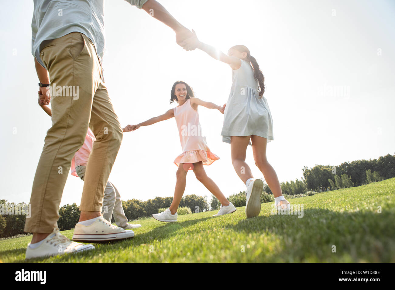Dancing together. Happy family holding hands and dancing in the circle ...