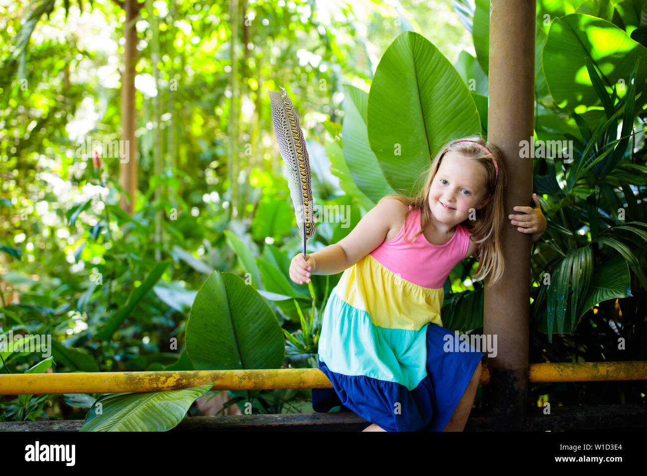Child playing with big bird feather. Little girl found huge feathers at ...