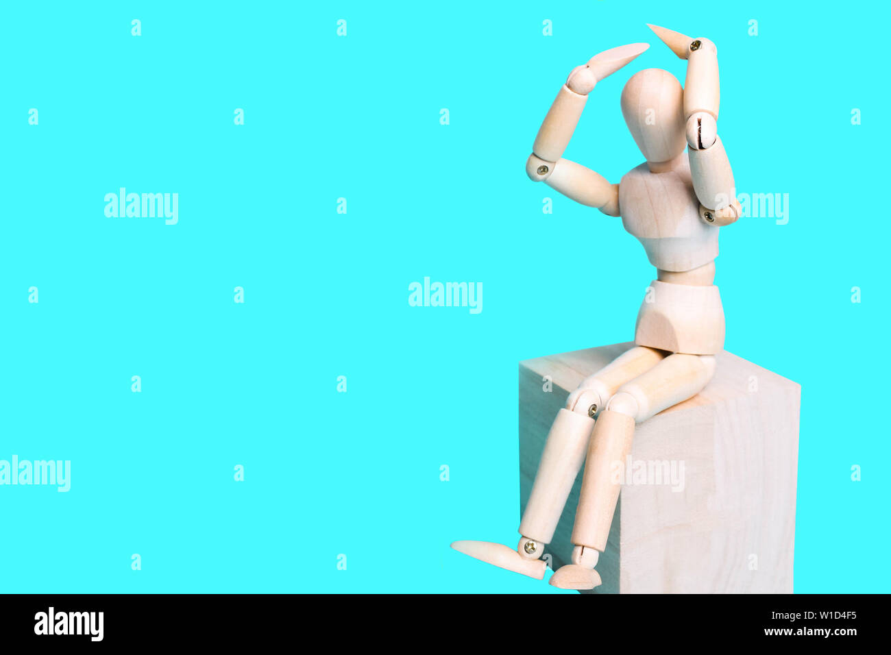 Wooden human figure on a blue background. Concept of pain in the head ...