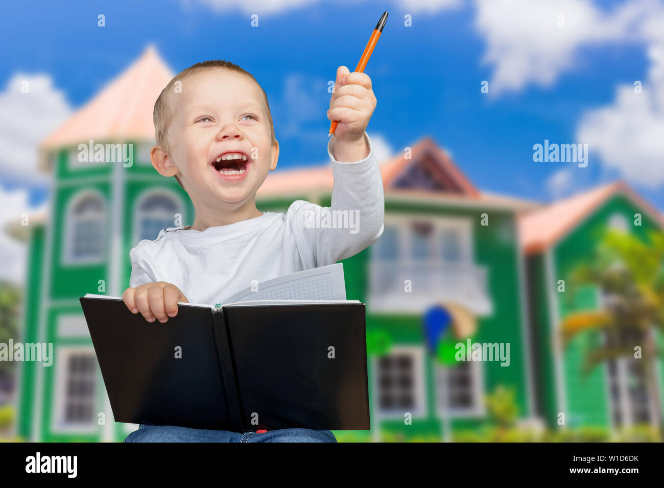 Cheerful little boy pointing up Stock Photo - Alamy