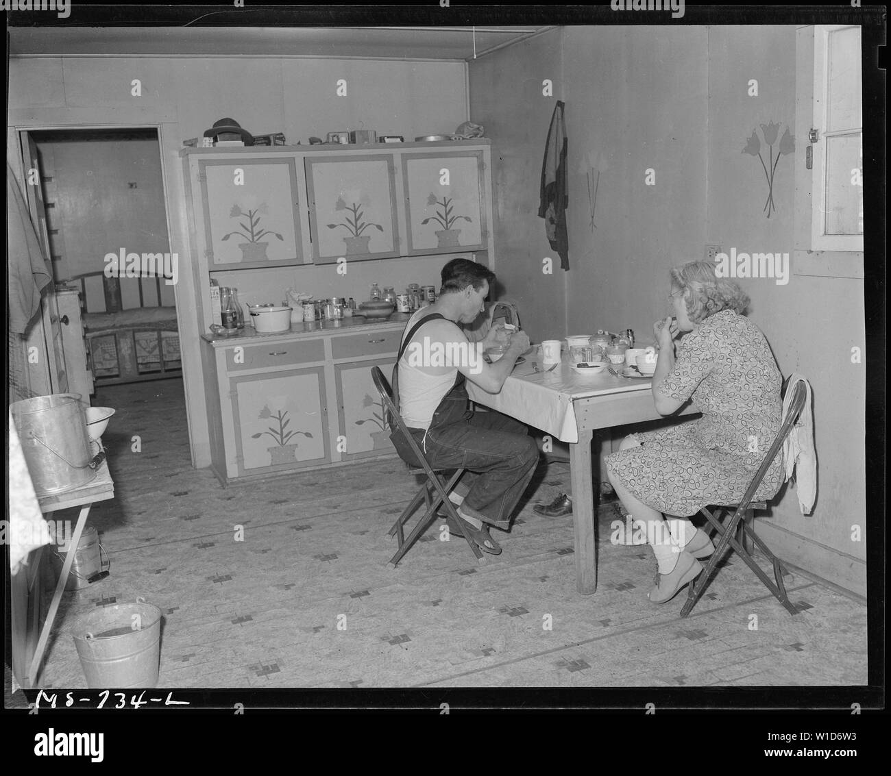 Fred Nutter, miner, and wife eating lunch in kitchen of their box car ...