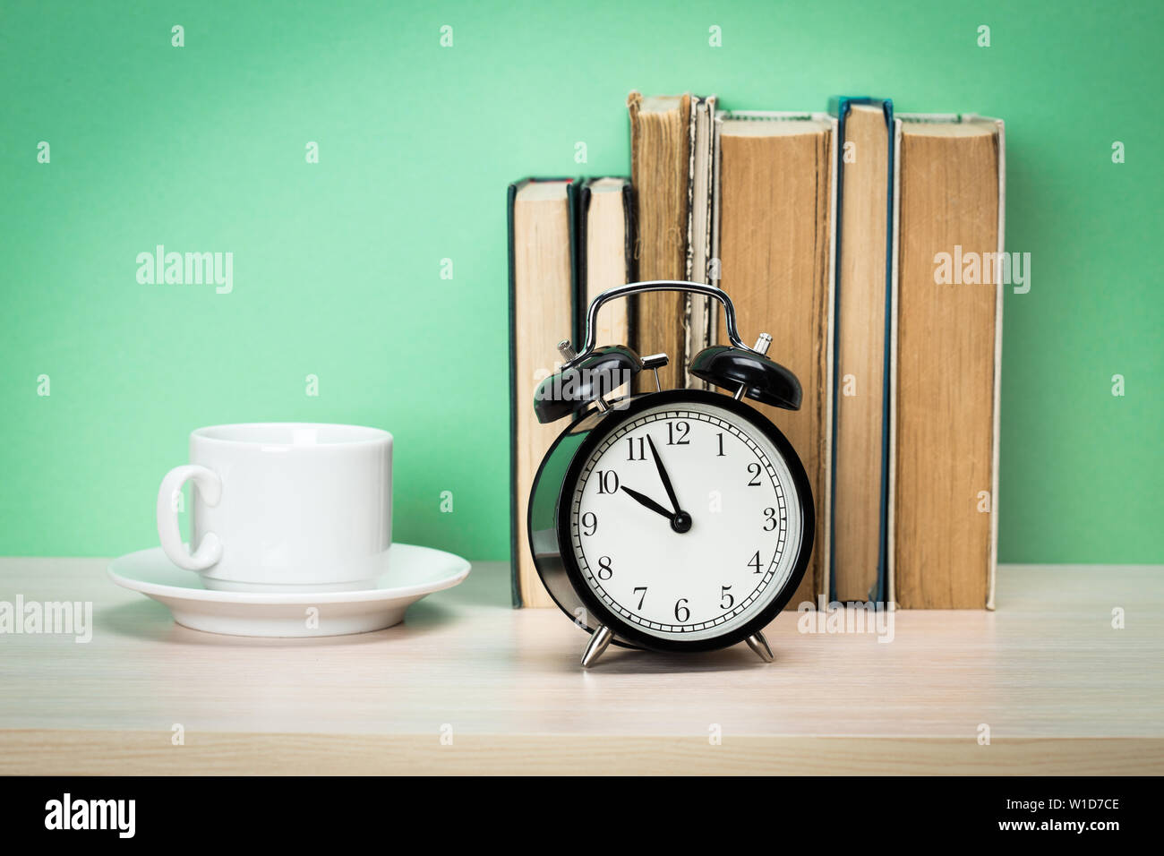 Retro alarm clock on a table Stock Photo - Alamy