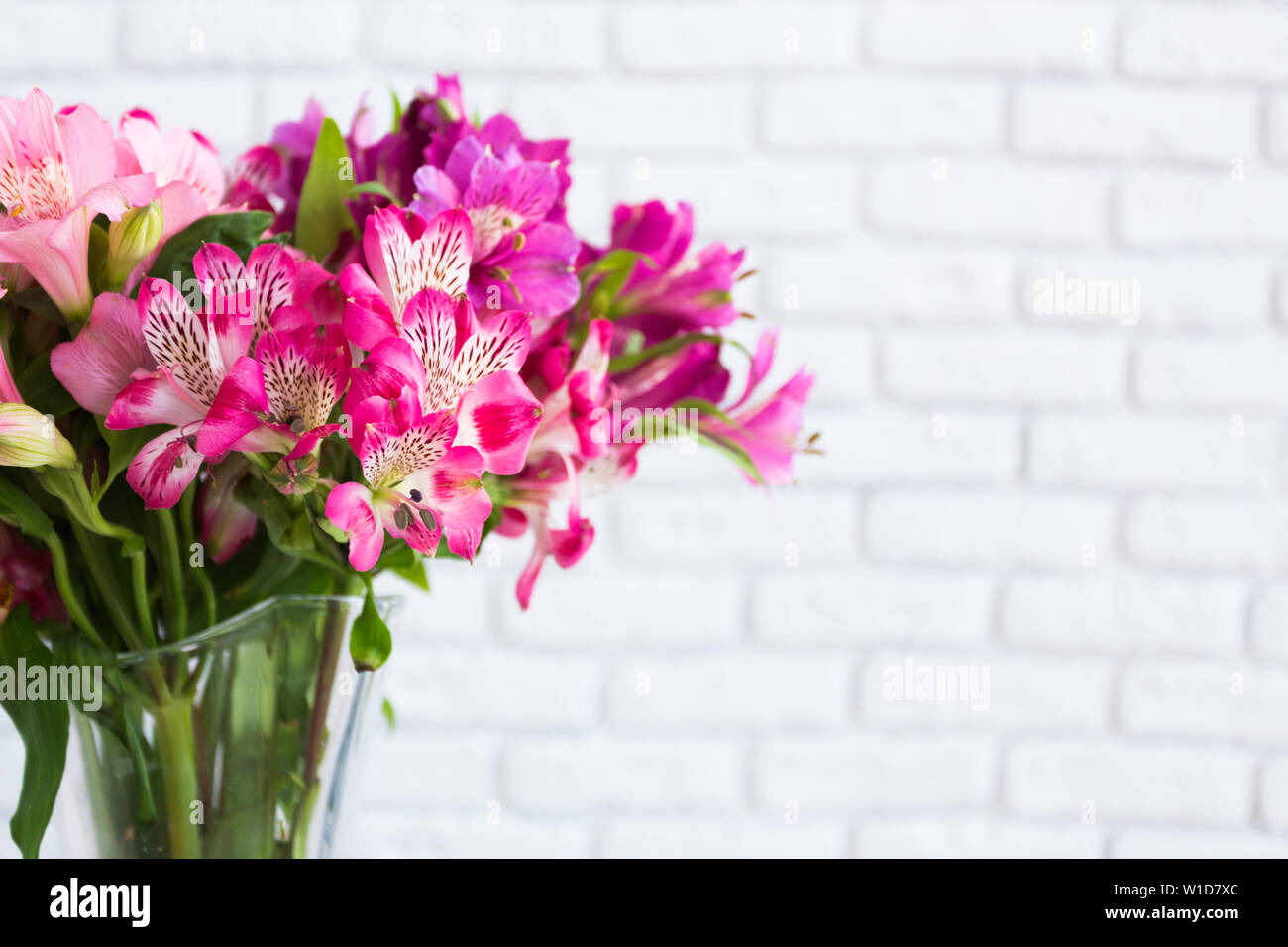 Vase full of colorful flowers on table Stock Photo - Alamy