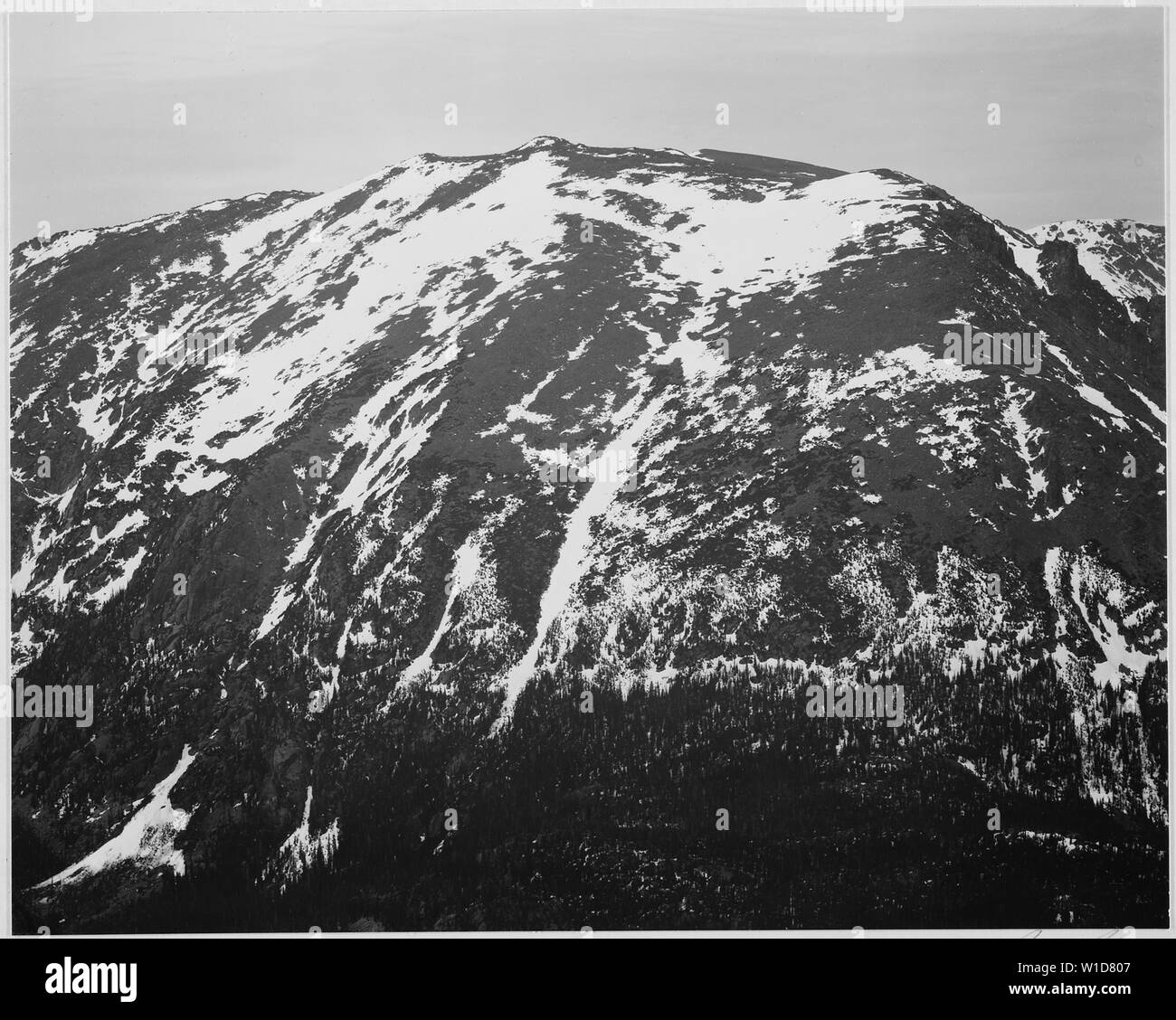 Full view of barren mountain side with snow, In Rocky Mountain National ...