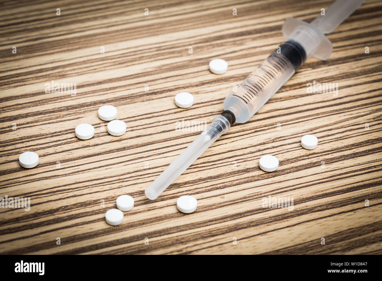 Still life drugs and syringe on table Stock Photo - Alamy