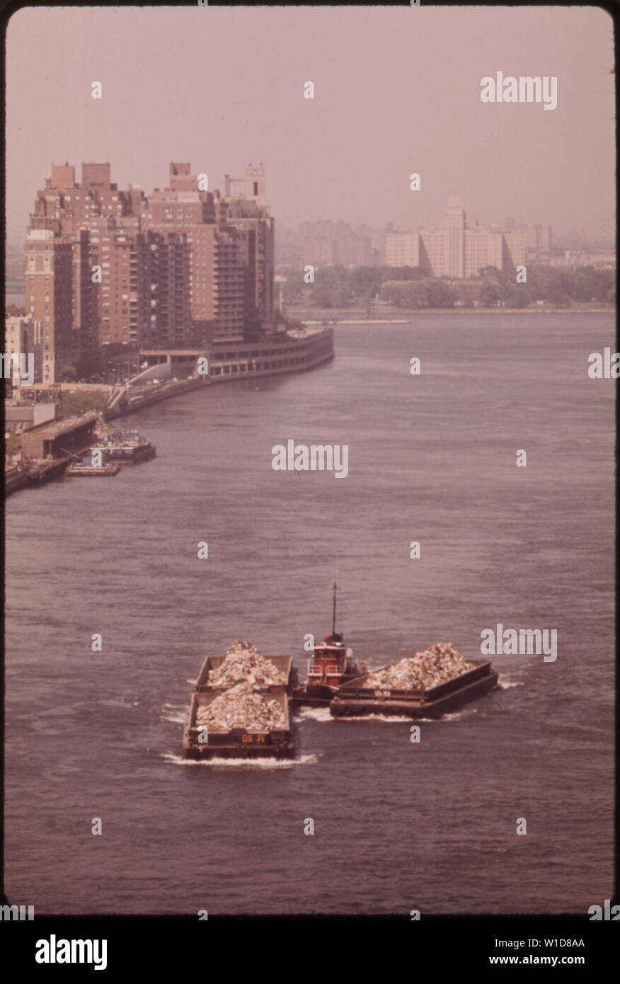 GARBAGE SCOWS BEING TOWED DOWN THE EAST RIVER ARE SEEN FROM THE 59TH ...