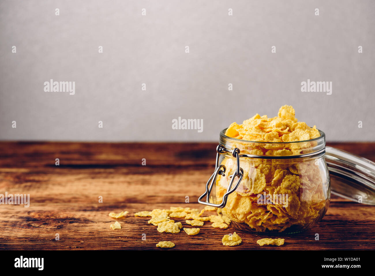 Corn flakes in a glass jar on wooden surface Stock Photo - Alamy