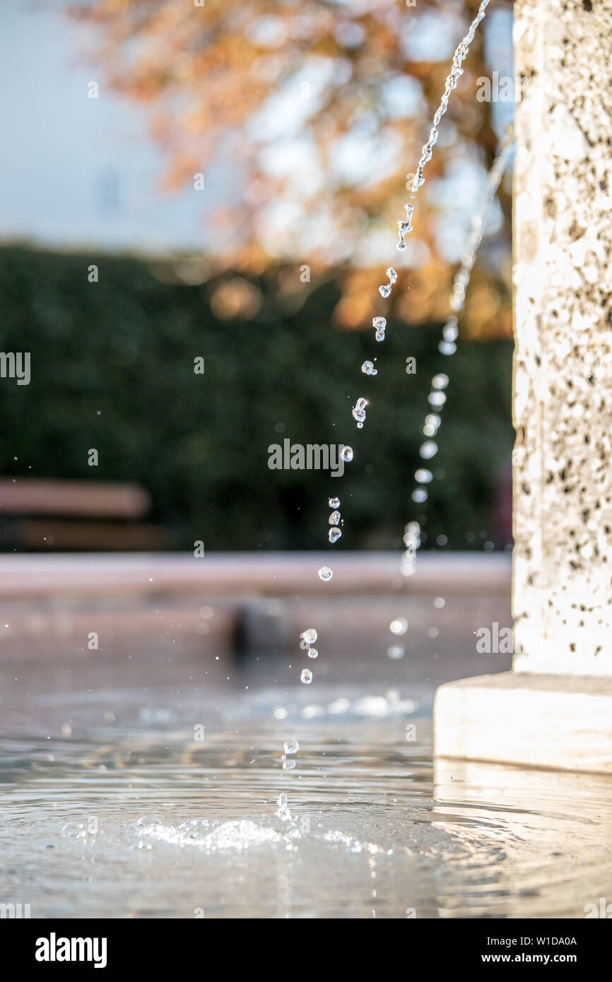 Fresh water drops falling into a well, summer time Stock Photo - Alamy