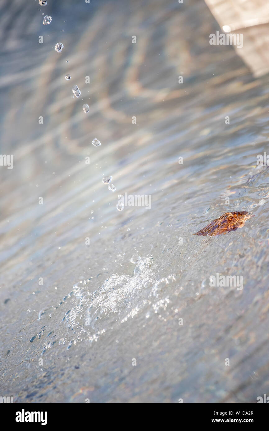 Fresh water drops falling into a well, summer time Stock Photo - Alamy