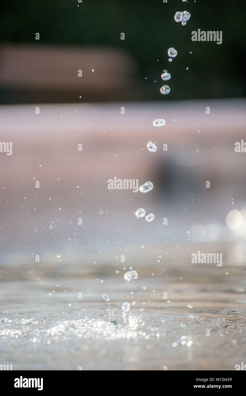 Fresh water drops falling into a well, summer time Stock Photo - Alamy