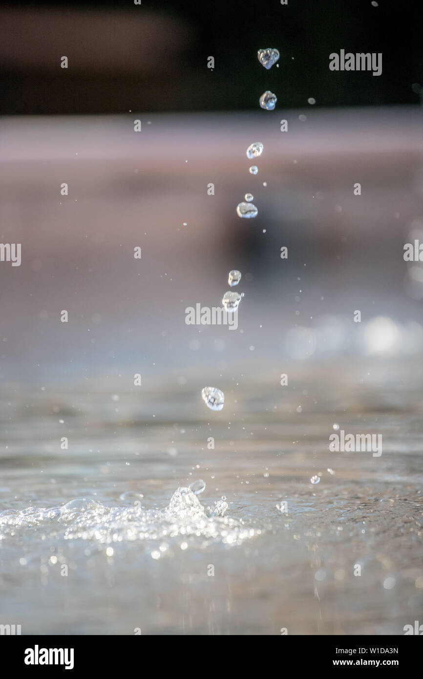 Fresh water drops falling into a well, summer time Stock Photo - Alamy