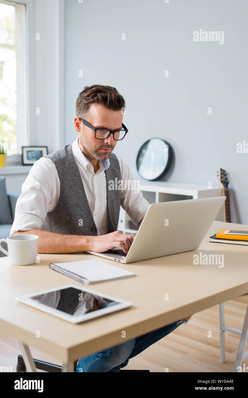 Designer working on laptop from home Stock Photo - Alamy