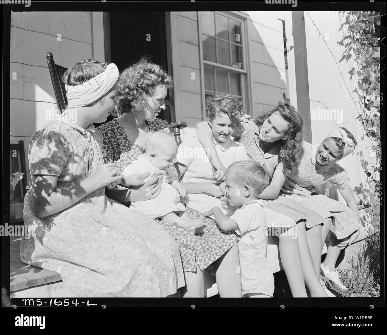 Gathering of women and children in front porch of miners home. Koppers ...