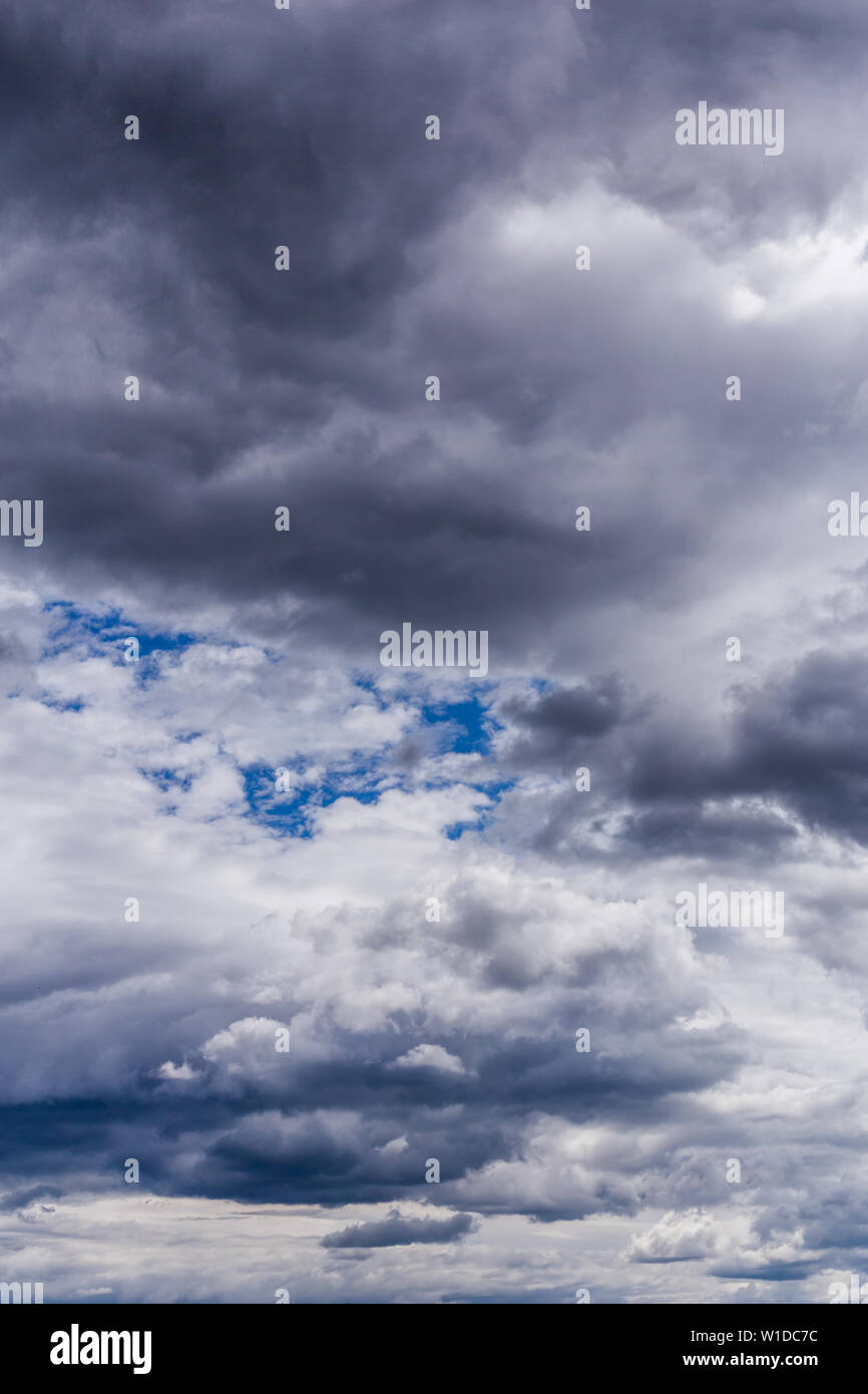 gray incoming storm clouds closeup backdrop, captured with telephoto ...