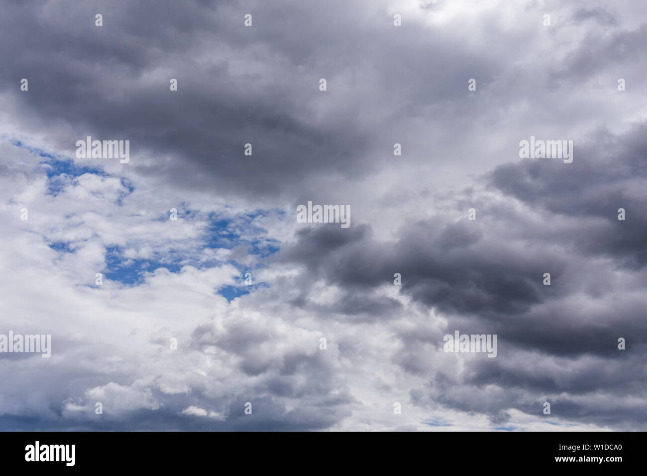 gray incoming storm clouds closeup backdrop, captured with telephoto ...