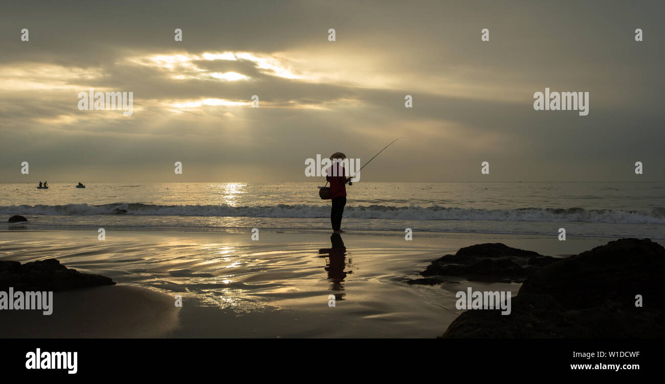 PHAN THIET, VIETNAM: Lonely fishman at the beach at sunrise Stock Photo ...