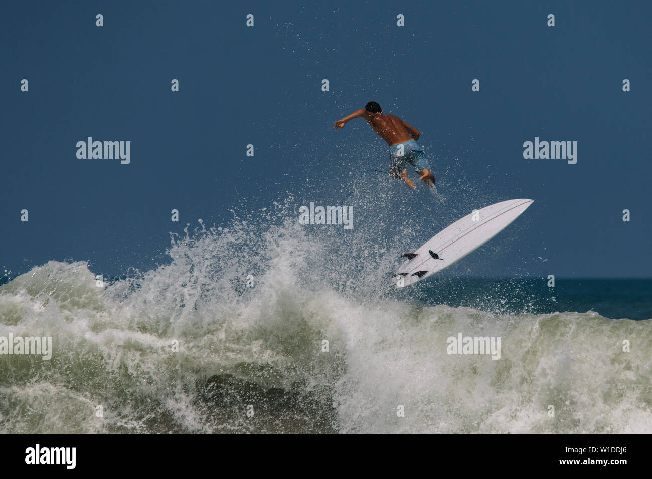 Surfer's crash on the high wave in Bali Stock Photo - Alamy