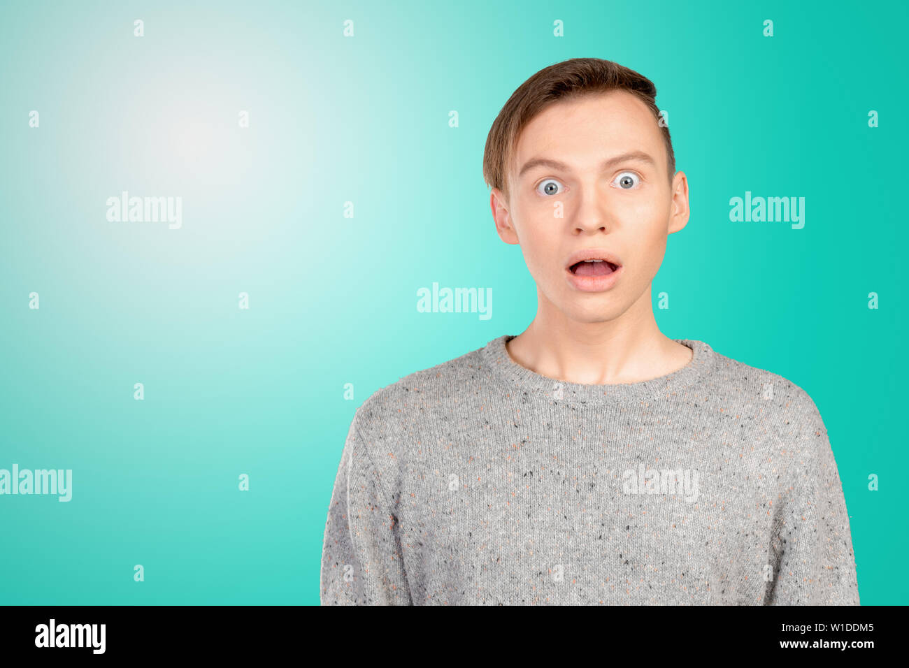 Portrait of young man with shocked facial expression Stock Photo - Alamy