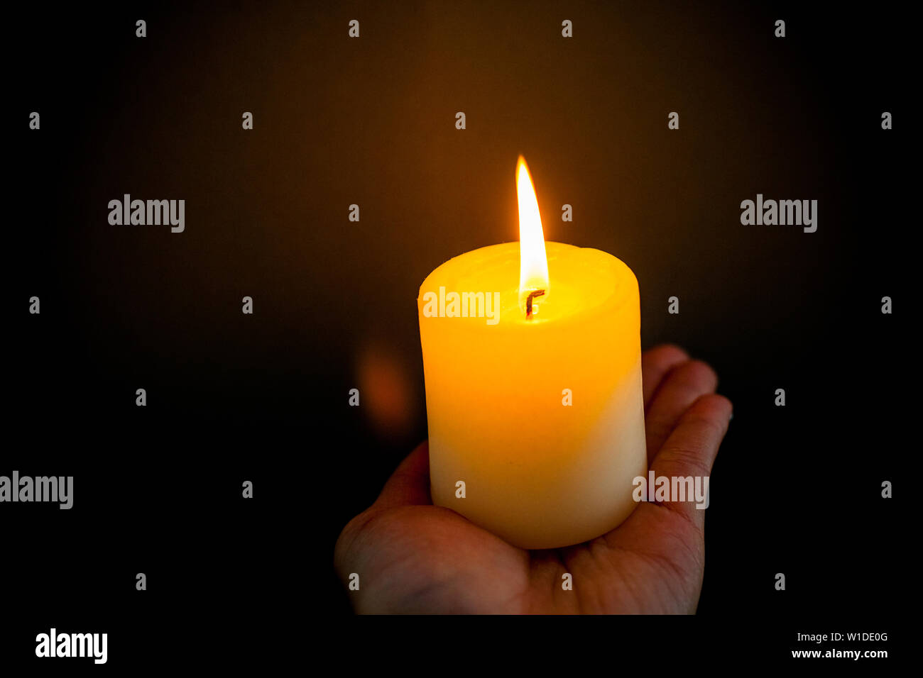 Candle in the hand Stock Photo - Alamy