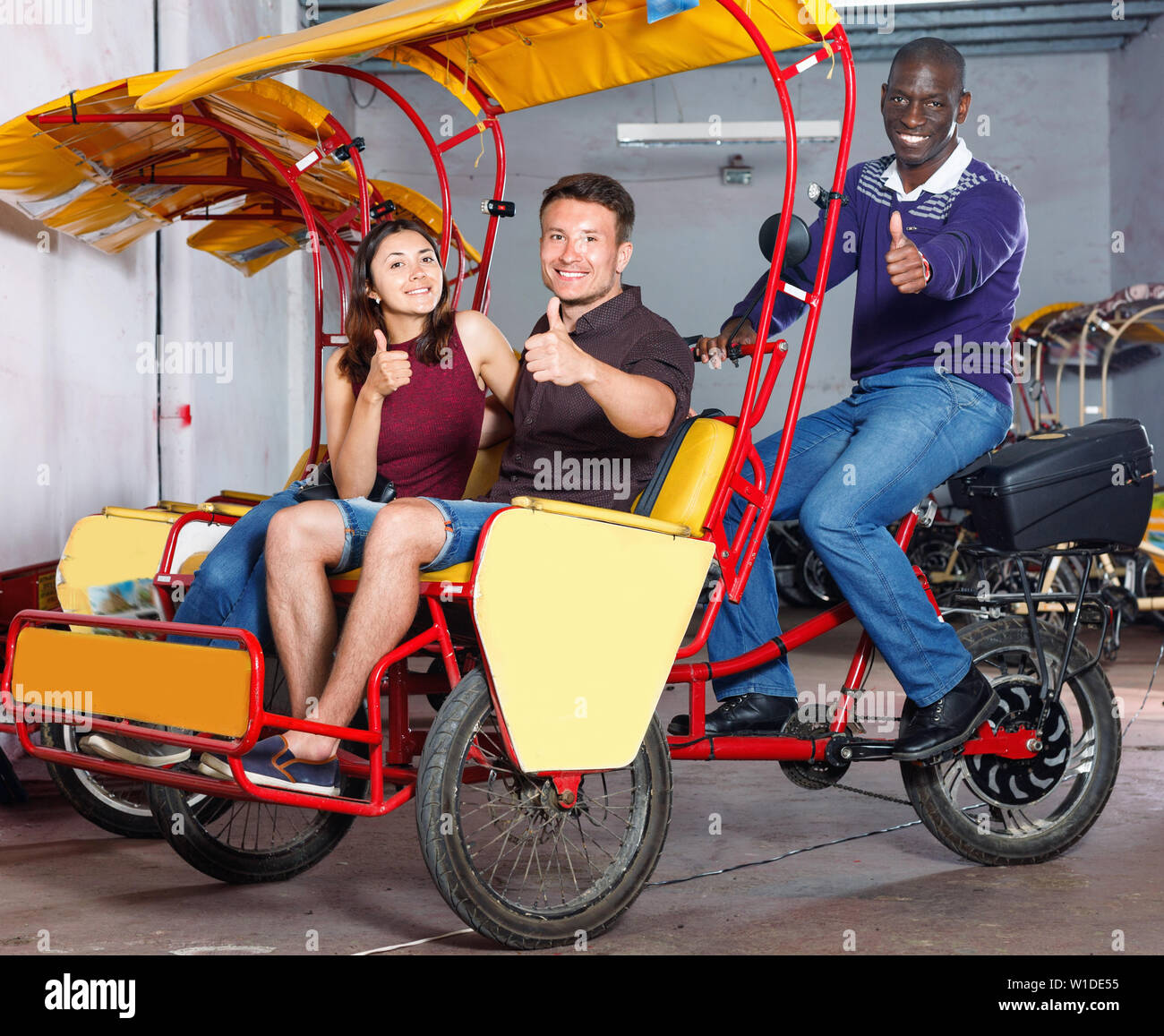 Happy young cheerful smiling couple sitting on rickshaw with friendly ...