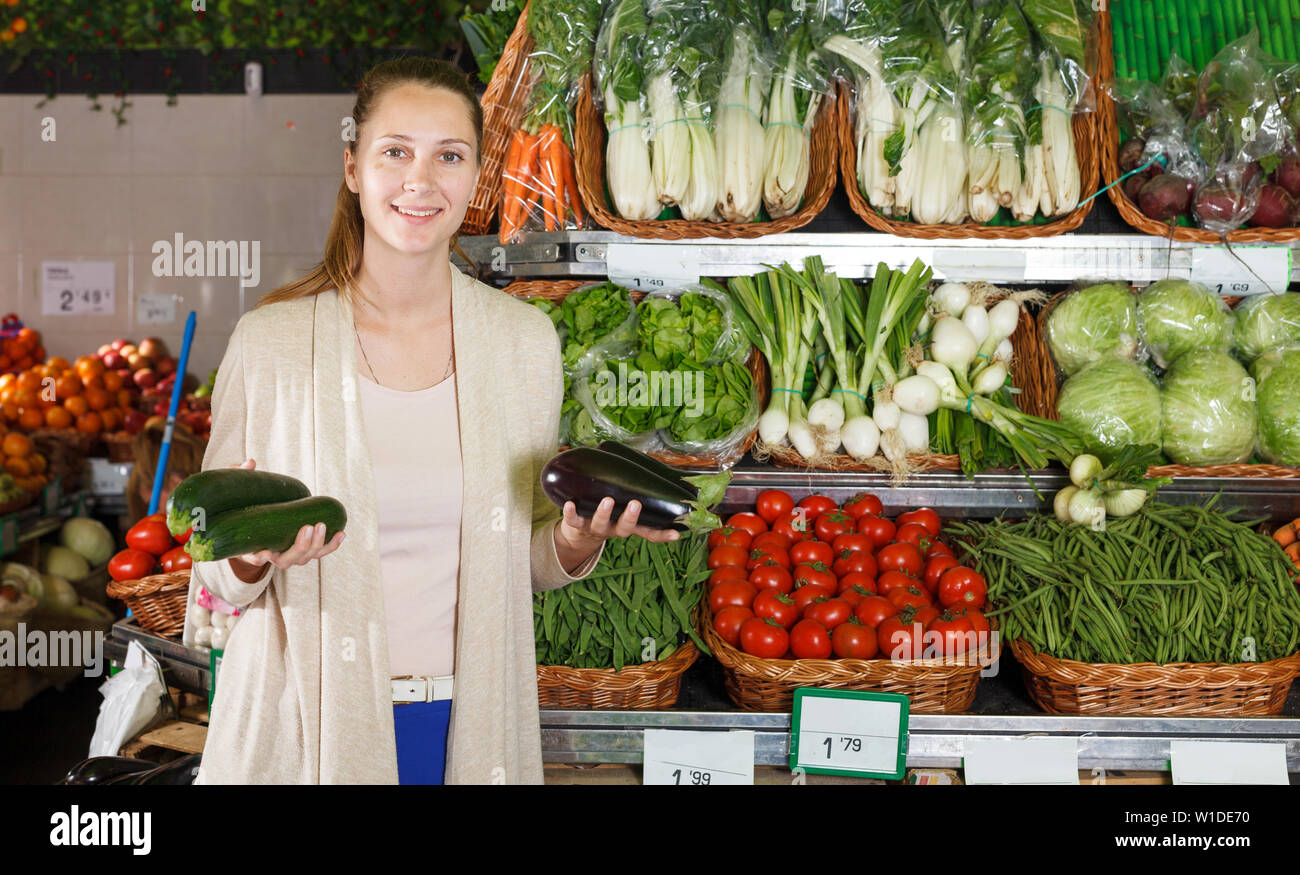 Portrait of woman who is choosing vegetables in the market Stock Photo ...