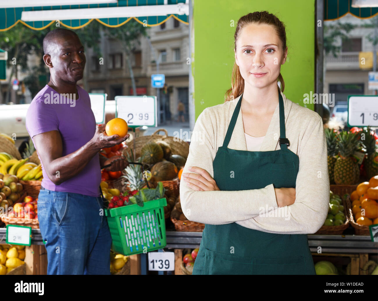 Portrait of confident seller woman who is standing on her workplace in ...