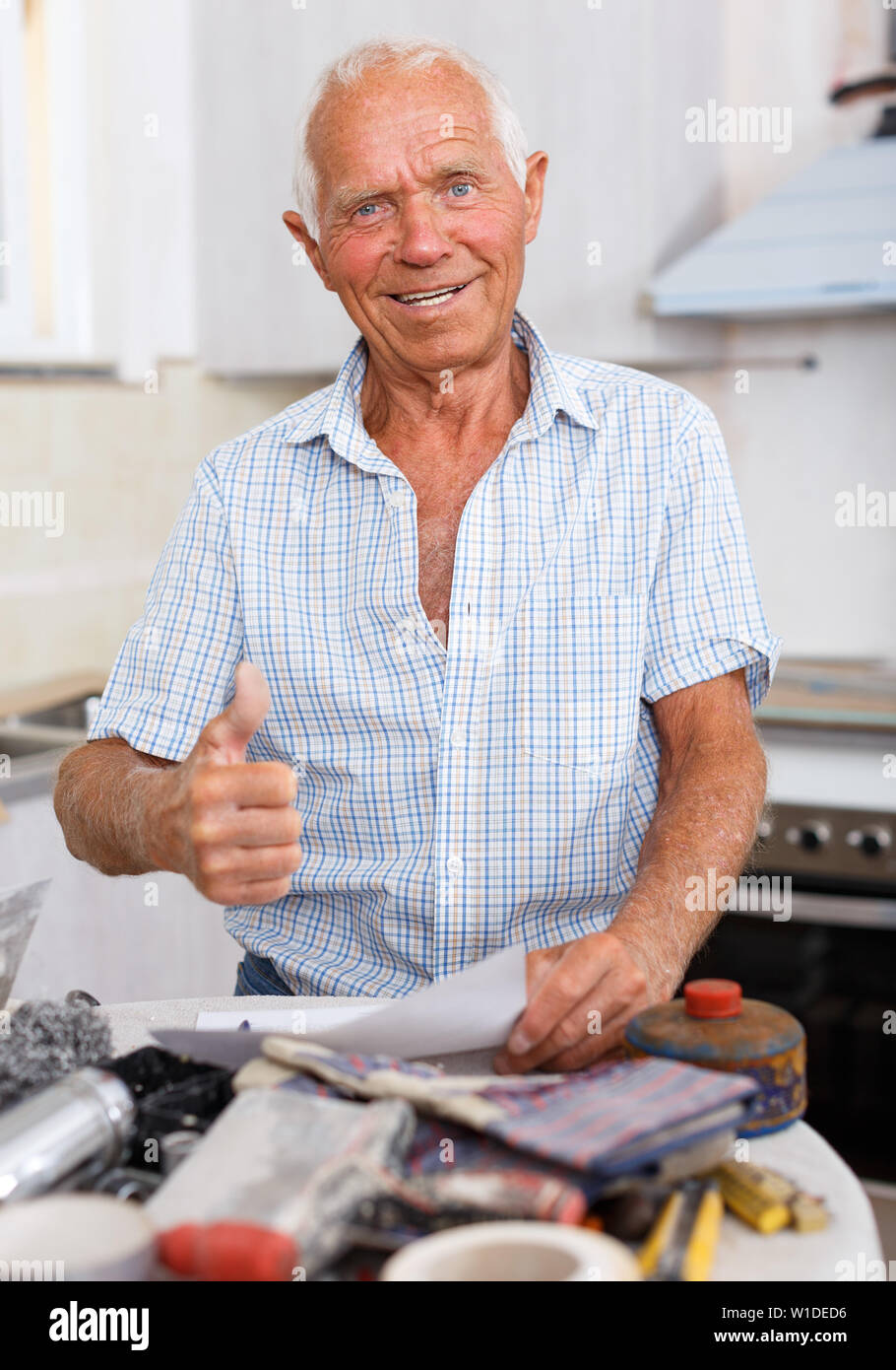 Enthusiastic older man planning upcoming repairs at his home, making ...