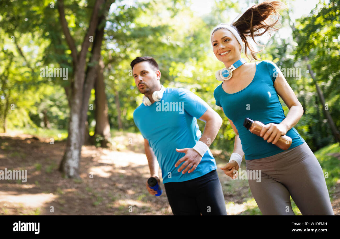 Happy couple running and exercising together outdoor Stock Photo - Alamy