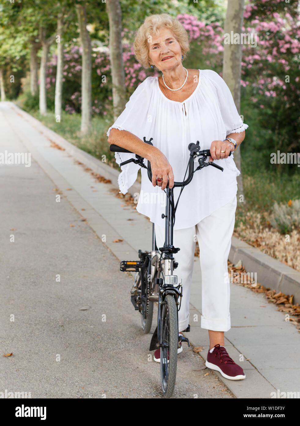 Senior caucasian woman having break in cycling, resting near bike Stock ...