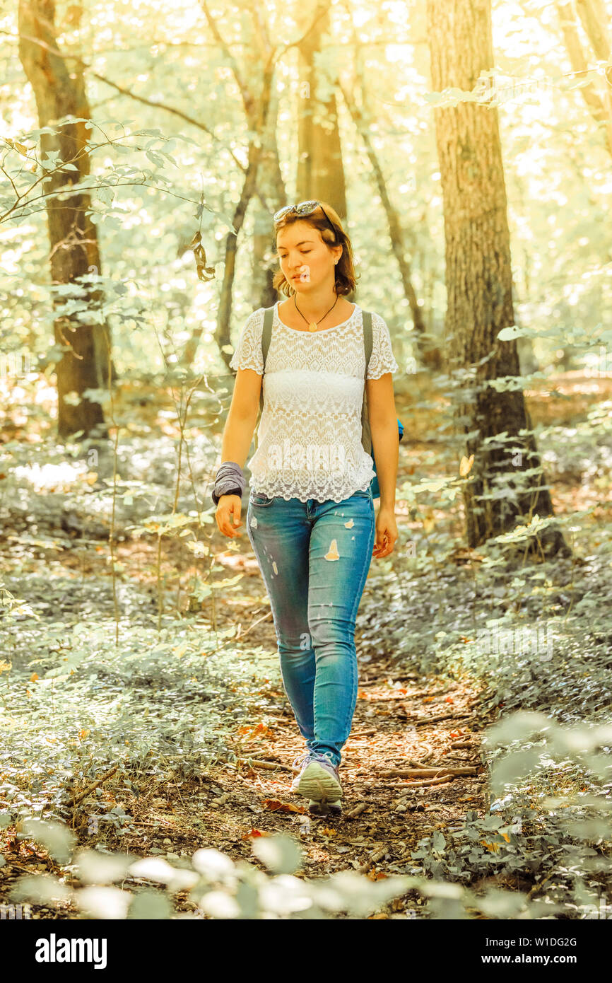 Caucasian young woman is walking in the wood, autumn Stock Photo - Alamy