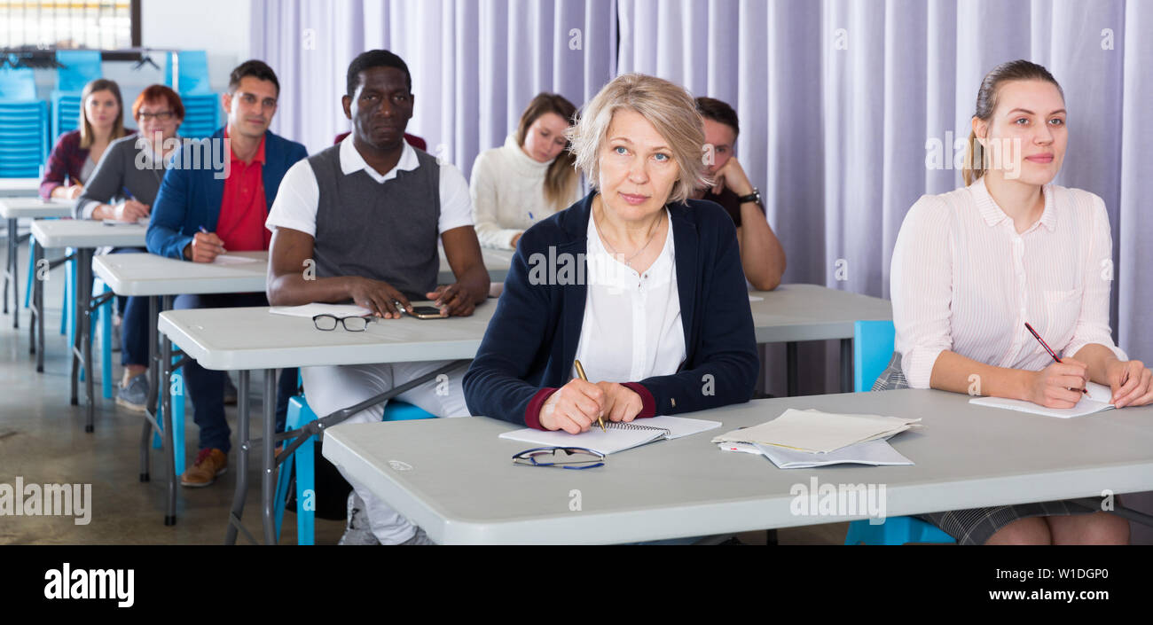 Multinational group of different age students at extension courses ...