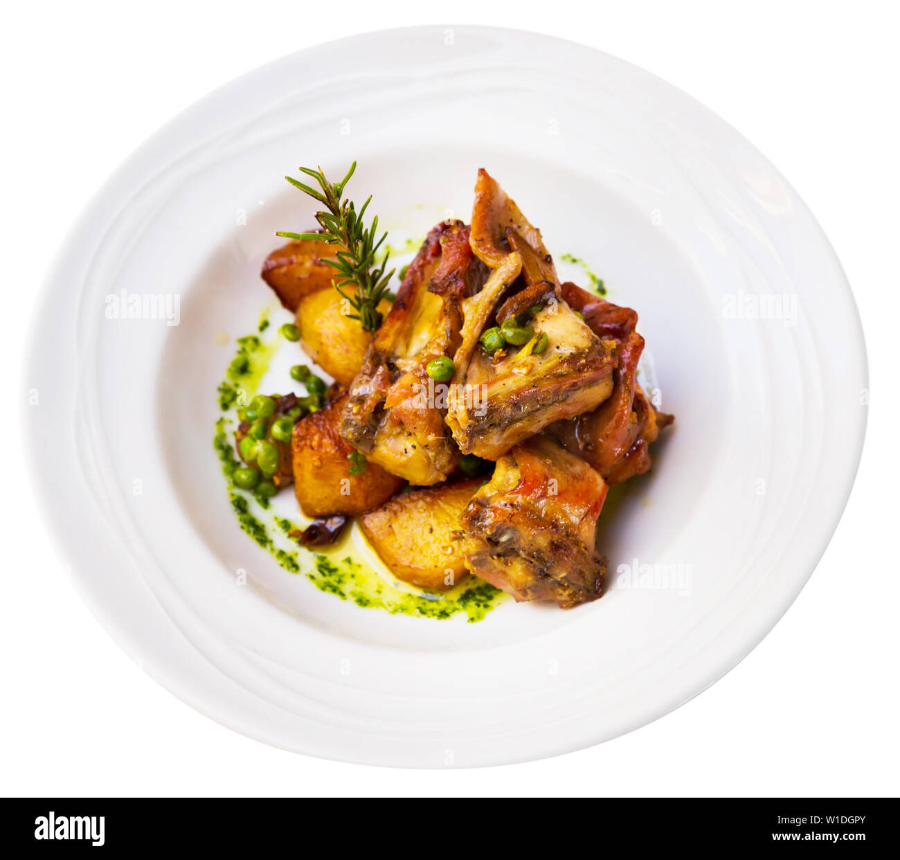 Delicious dish – rabbit meat with garlic served with peas and greens ...