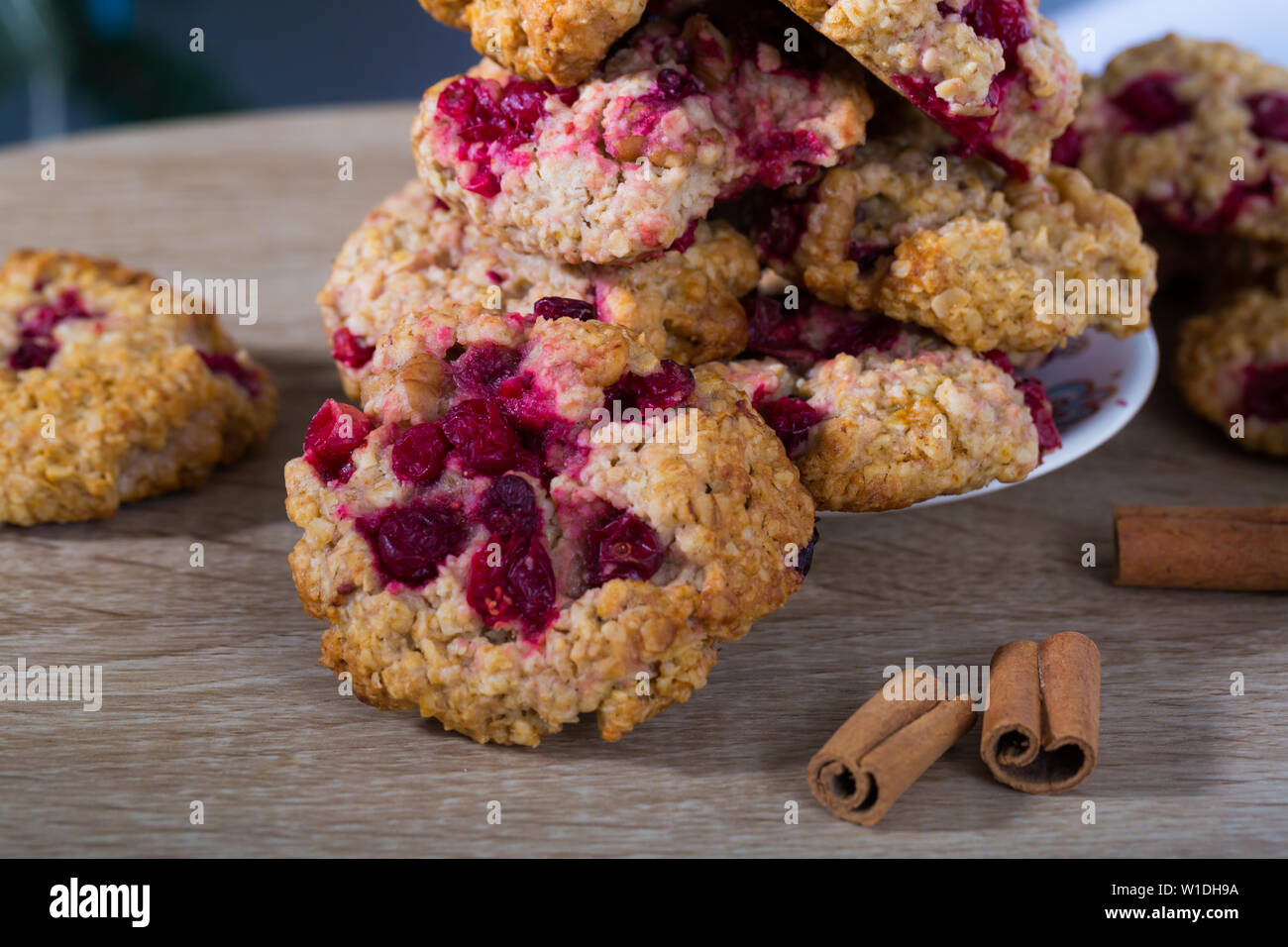 Closeup of homemade oatmeal cookies with berry on plate on wooden ...