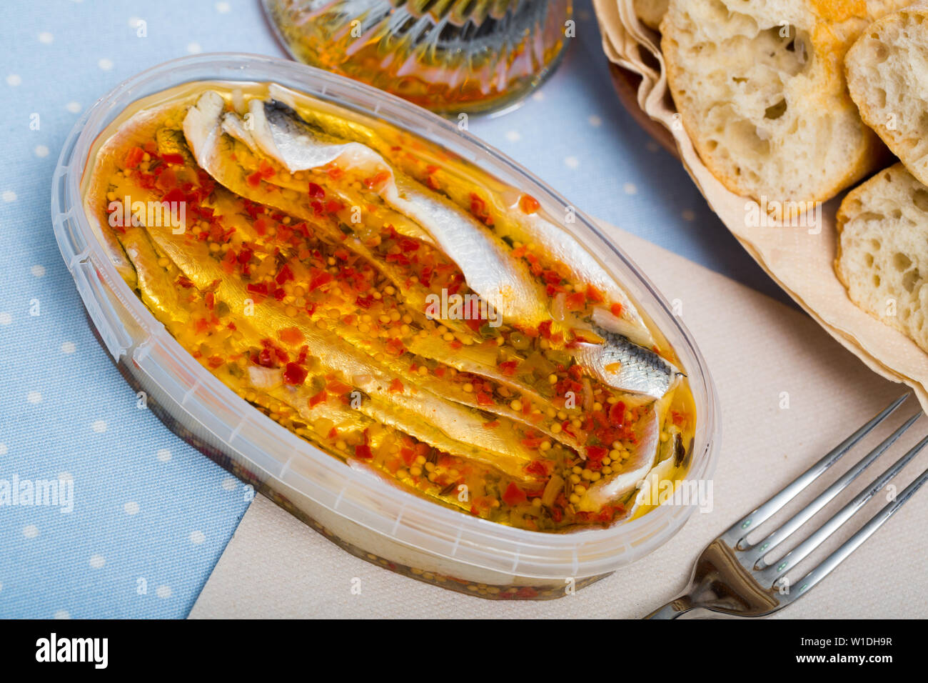 Preserved sardines marinated with spices in plastic container Stock ...