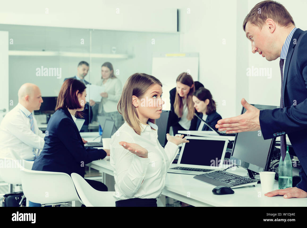 Boss scolding female subordinate pointing out shortcomings and misses ...