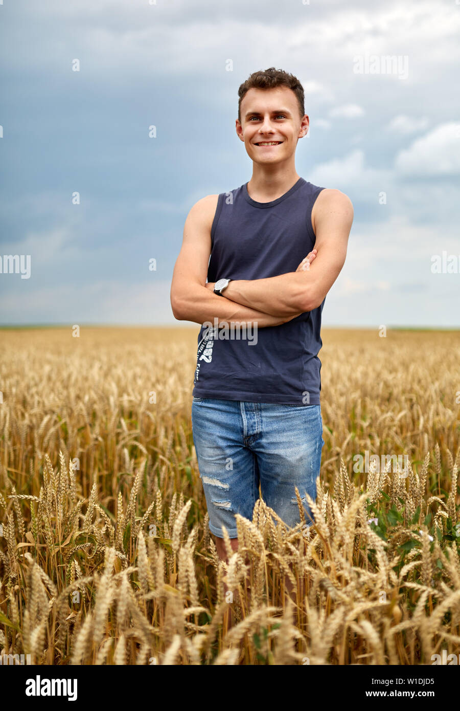 Portrait of a young farmer in a wheat field Stock Photo - Alamy