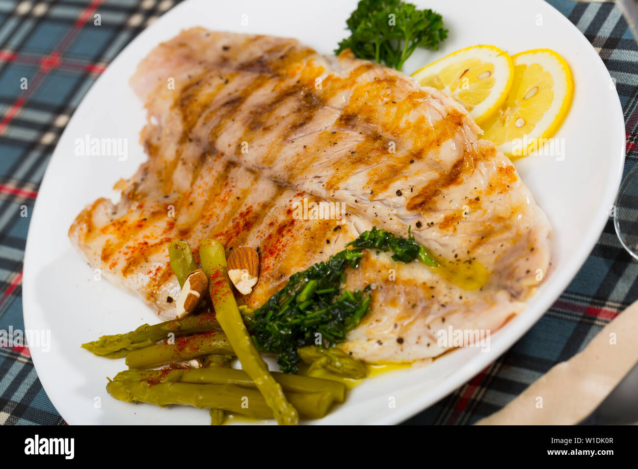 Roasted perch fish fillet served with pickled asparagus and parsley ...